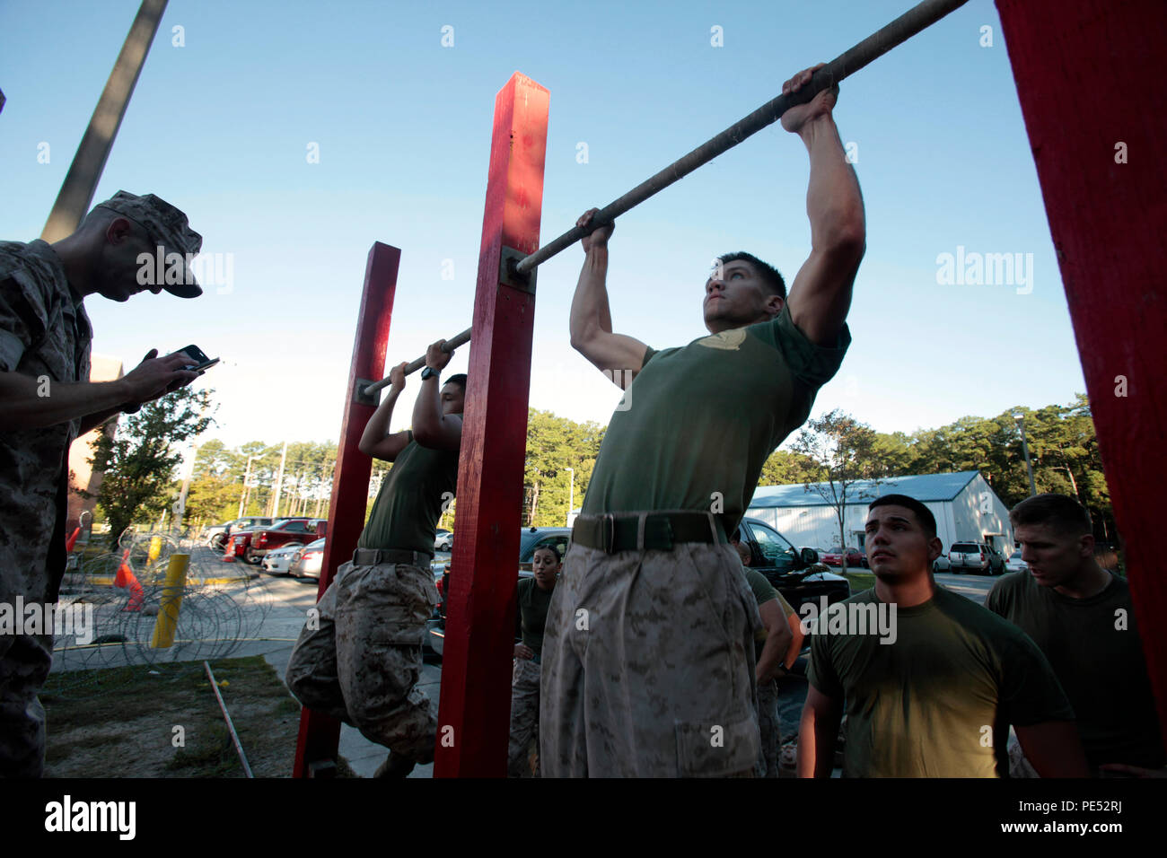 Marines perform pull-ups during a Super Squad Competition hosted by ...