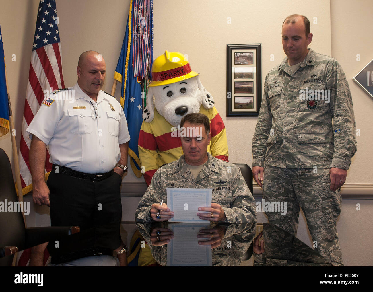Col. Richard Boutwell (front), 99th Air Base Wing commander, reviews ...