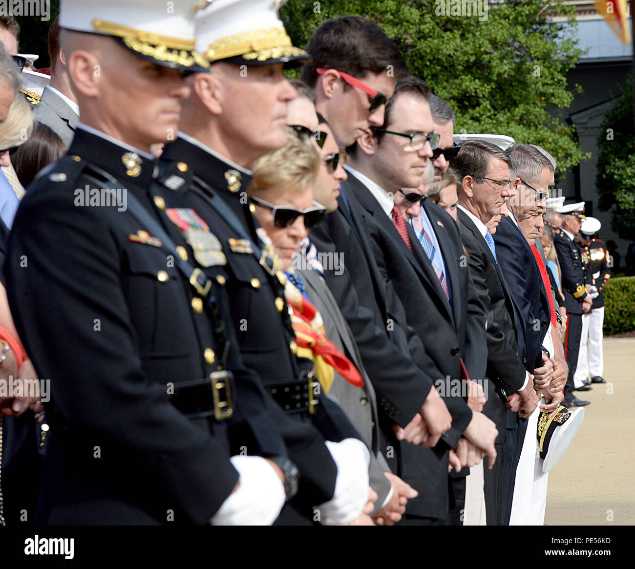 Secretary of Defense Ash Carter bows his head during the invocation for ...