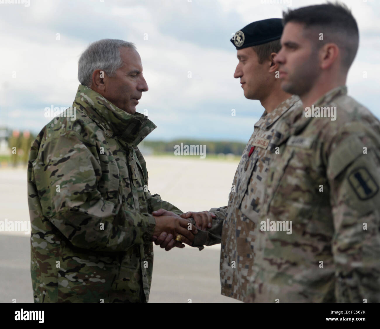Maj. Gen. Gregory Vadnais, Adjutant General of Michigan, shakes hands ...