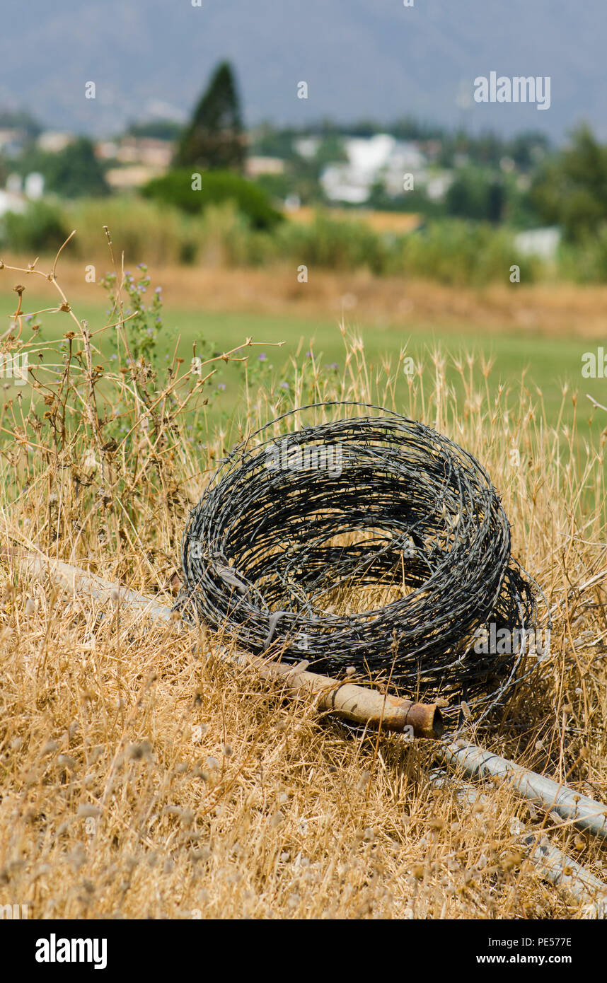 Barbed wire coil hi-res stock photography and images - Alamy