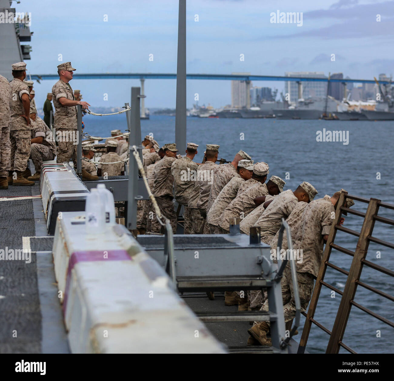 Marines and Sailors with the 13th Marine Expeditionary Unit look on as ...