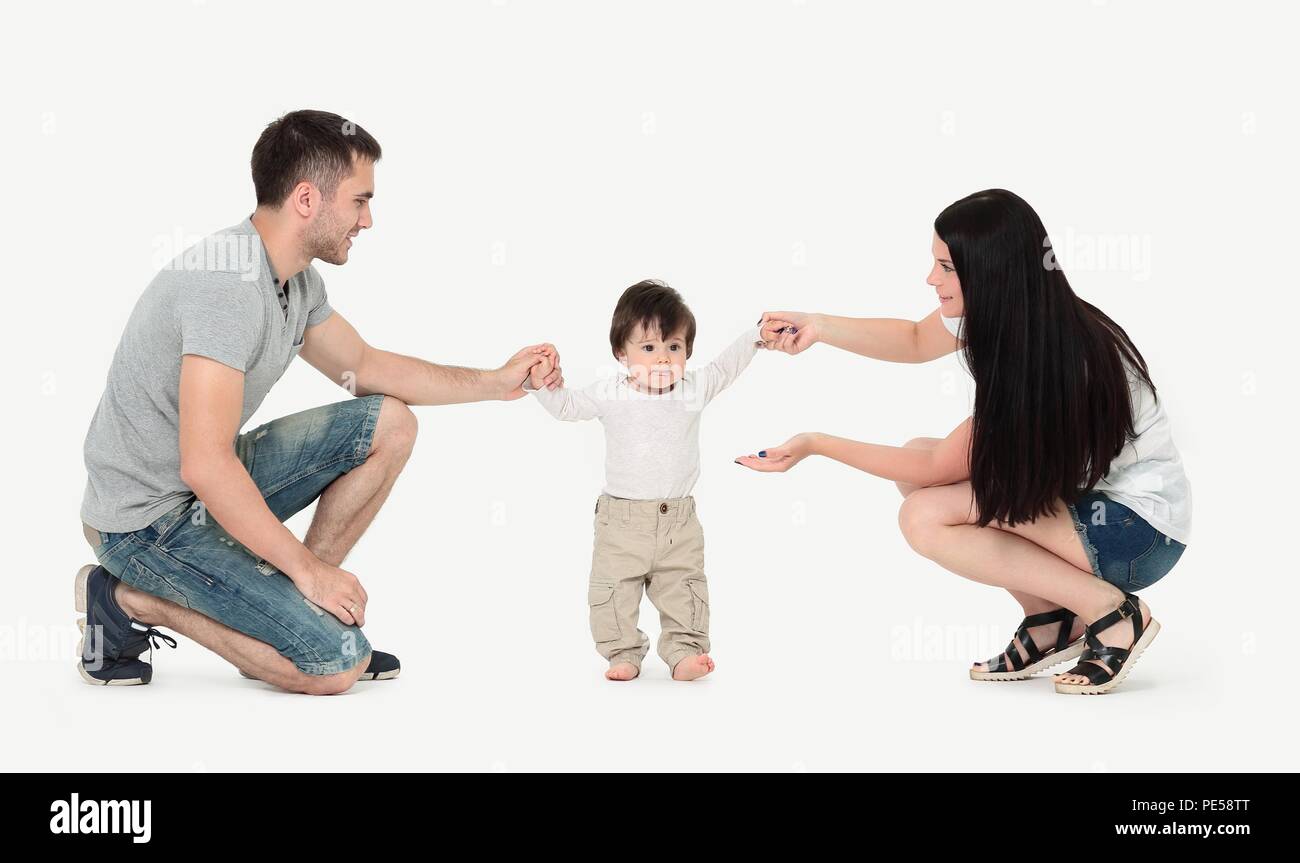 Portrait of a happy family that teaches a child to walk Stock Photo - Alamy