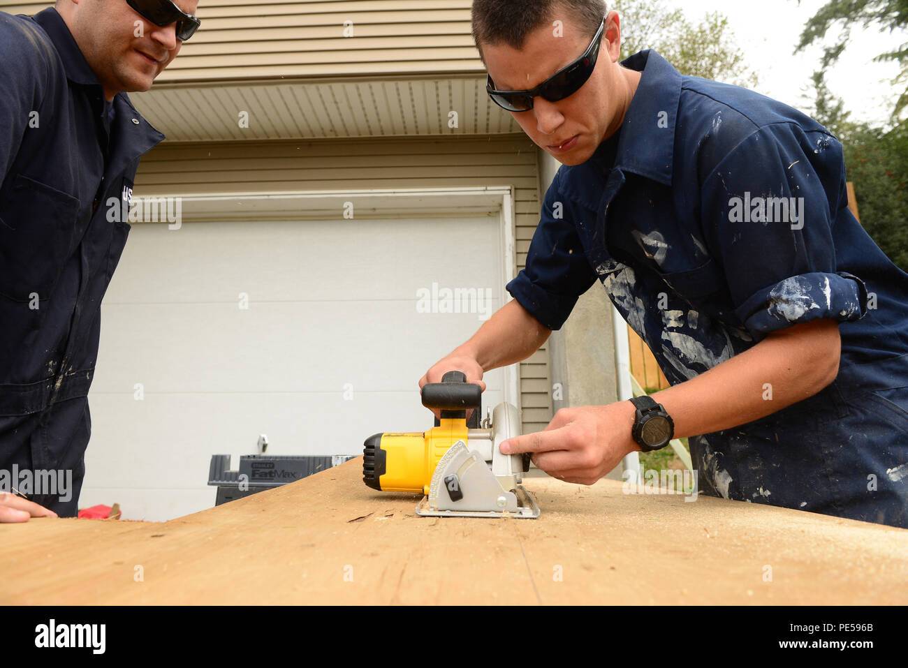 Petty Officer 3rd Class Kenneth Lawson, a damage controlman, and ...