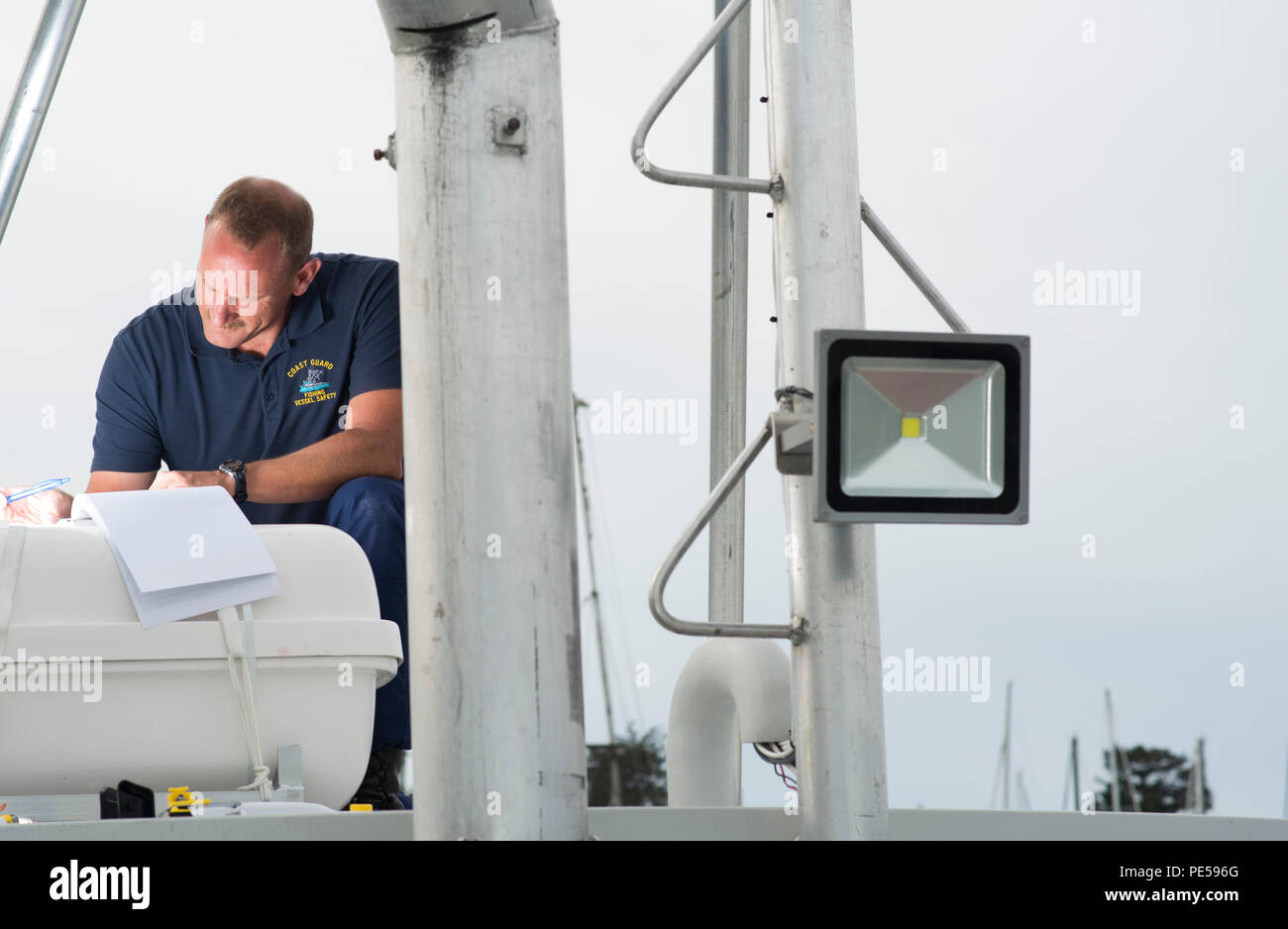 Lt. Cmdr. David Cripe, a Coast Guard marine inspector, checks the ...