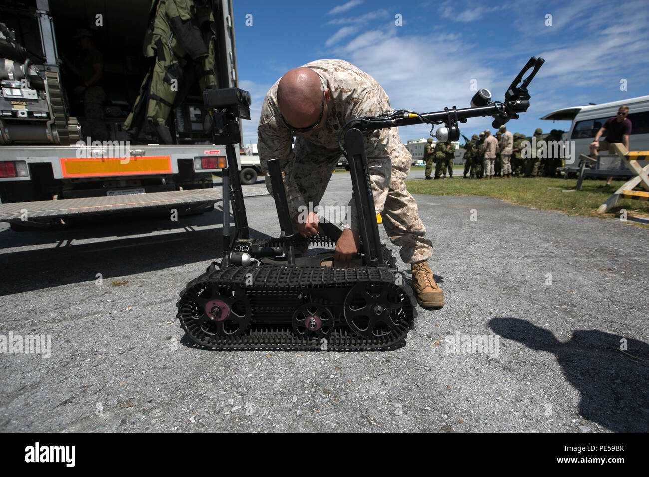 An explosive ordinance disposal technician activates an explosive ...