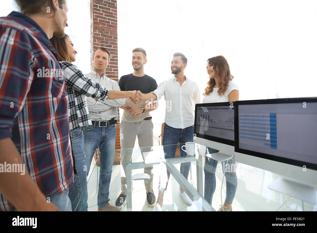 handshake young designer and the client Stock Photo - Alamy