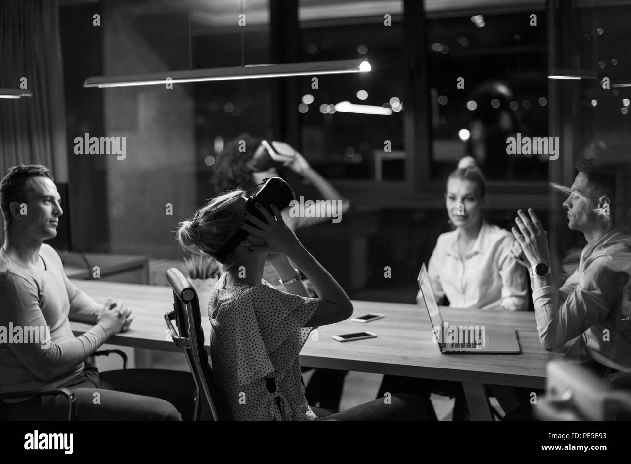 Multiethnic Business team using virtual reality headset in night office ...