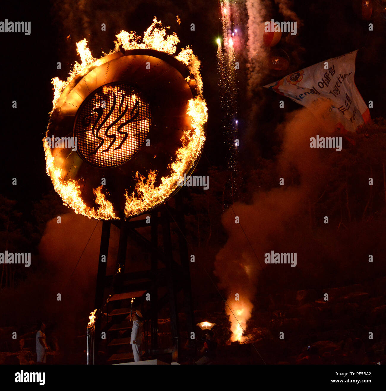 A South Korean Naval officer climbed a ladder with a torch to light the ...