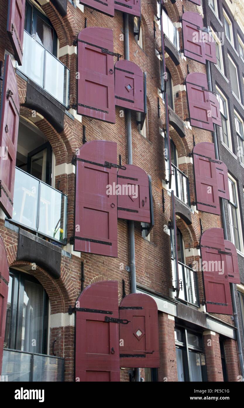 Amsterdam apartment building with red open wooden window shutters Stock ...