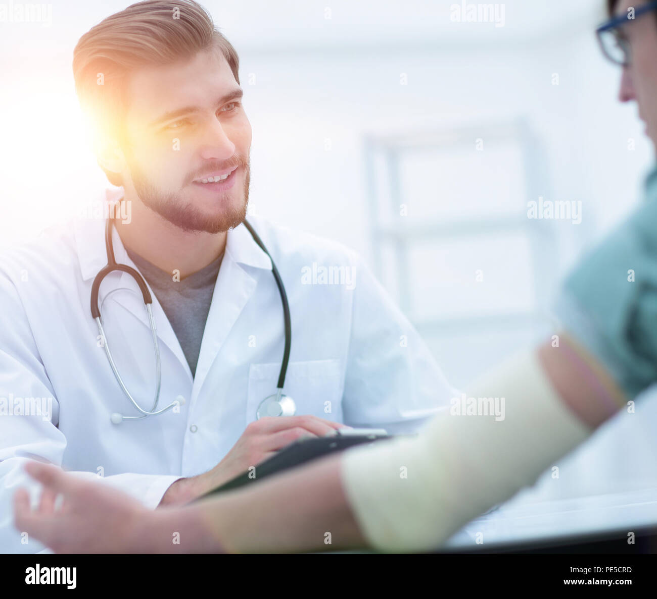 doctor writing a prescription to her patient Stock Photo - Alamy