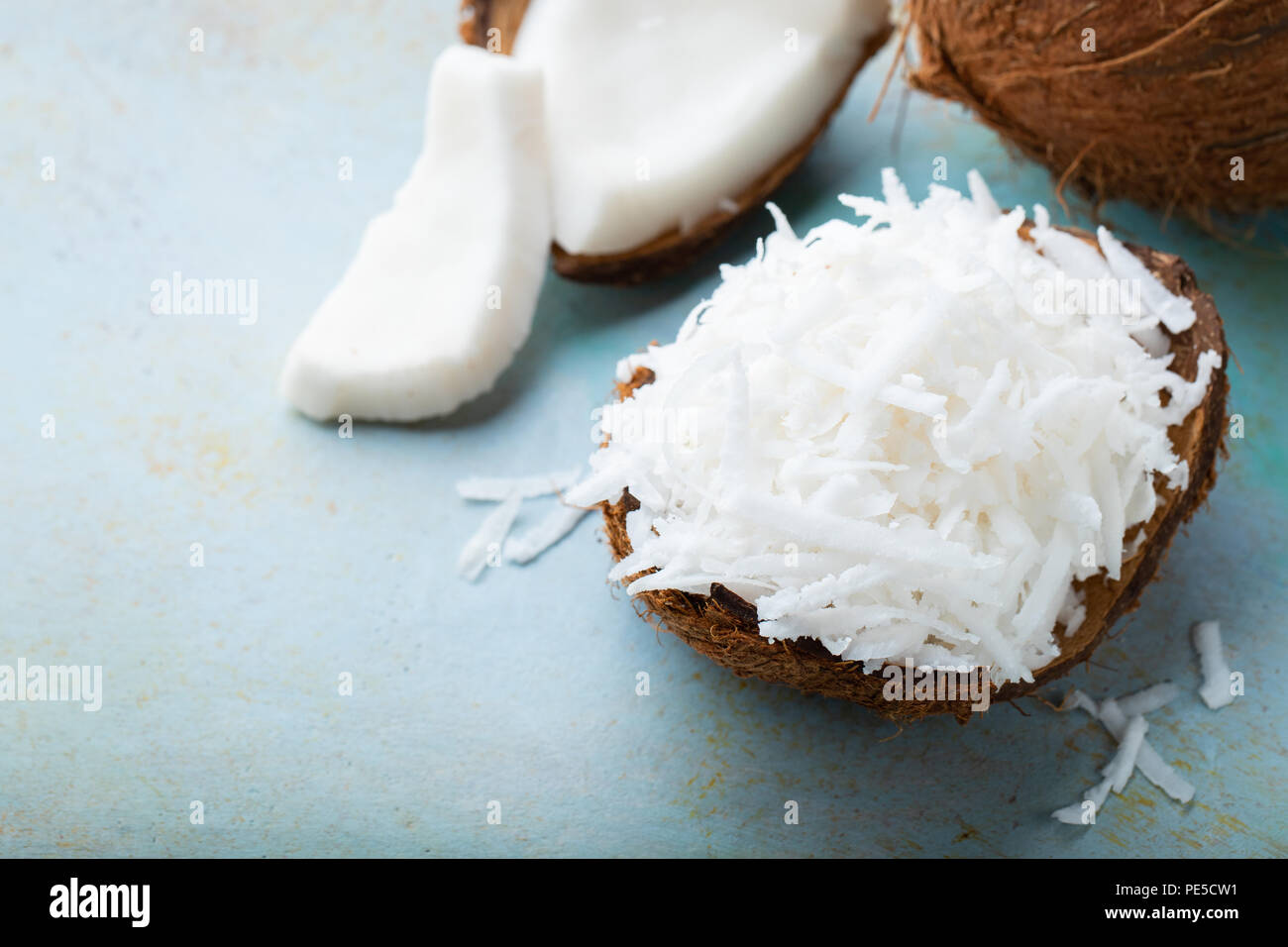 Coconut flakes in a shell on a blue background. with copy space Stock ...