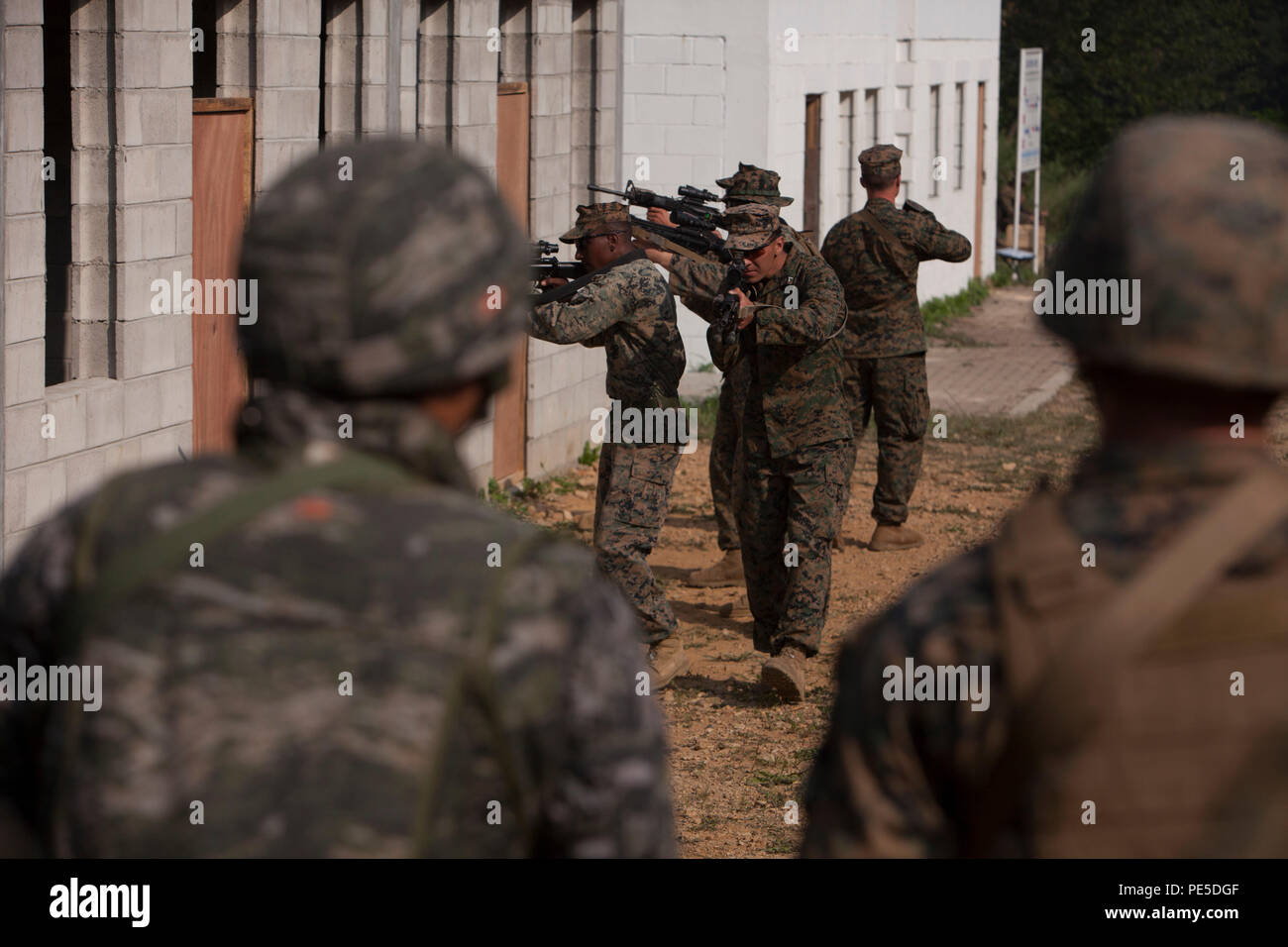 U.S. Marine Corps Lance Cpl. Michael W. Bollman, center, leads a ...