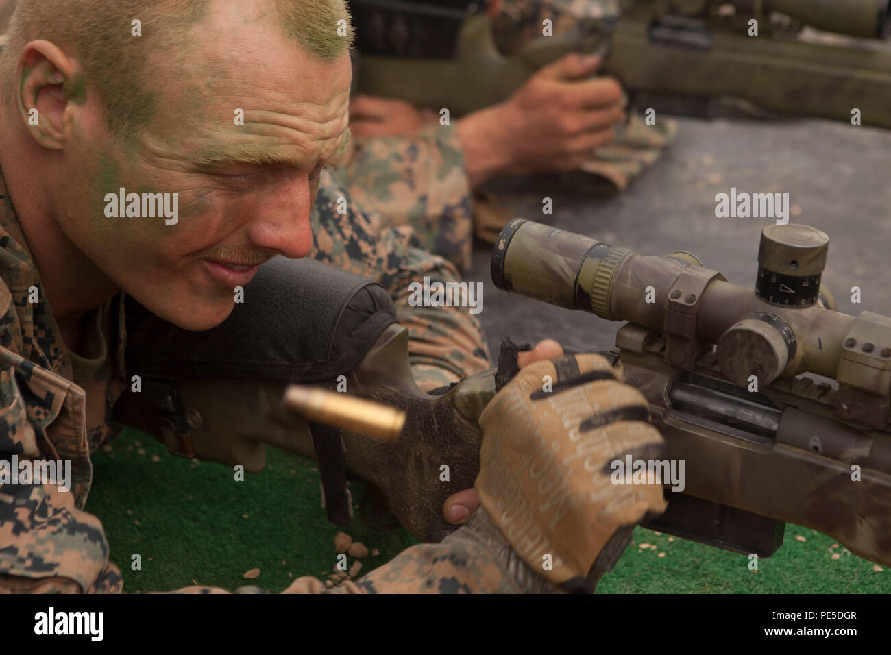 Cpl. Evan D. Taylor cycles the next round into the chamber of a M40A5 ...
