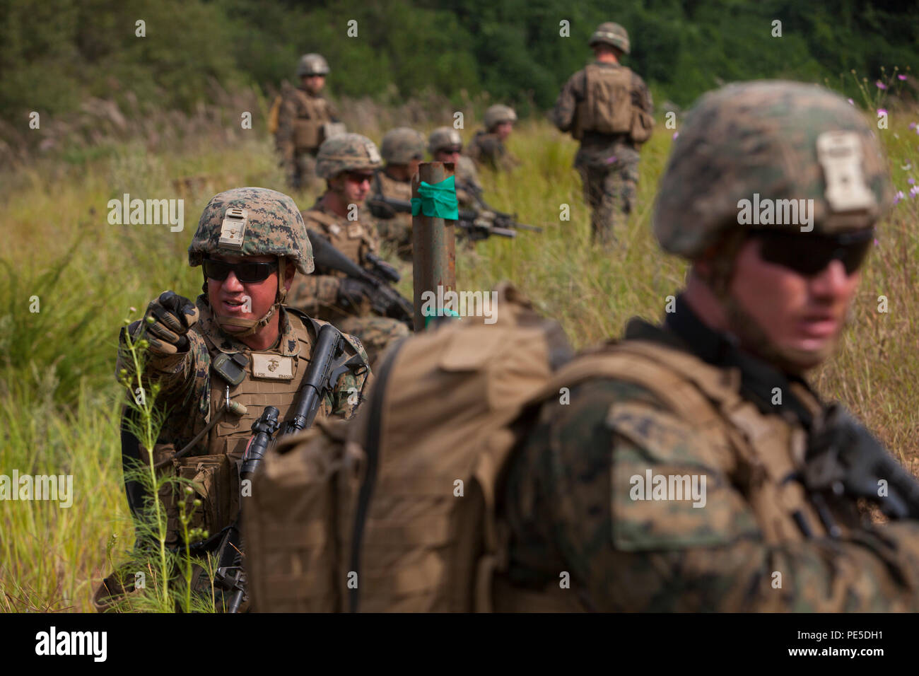 U.S. Marine Corps Sgt. Cory D. Ward, left, directs Marines toward a ...