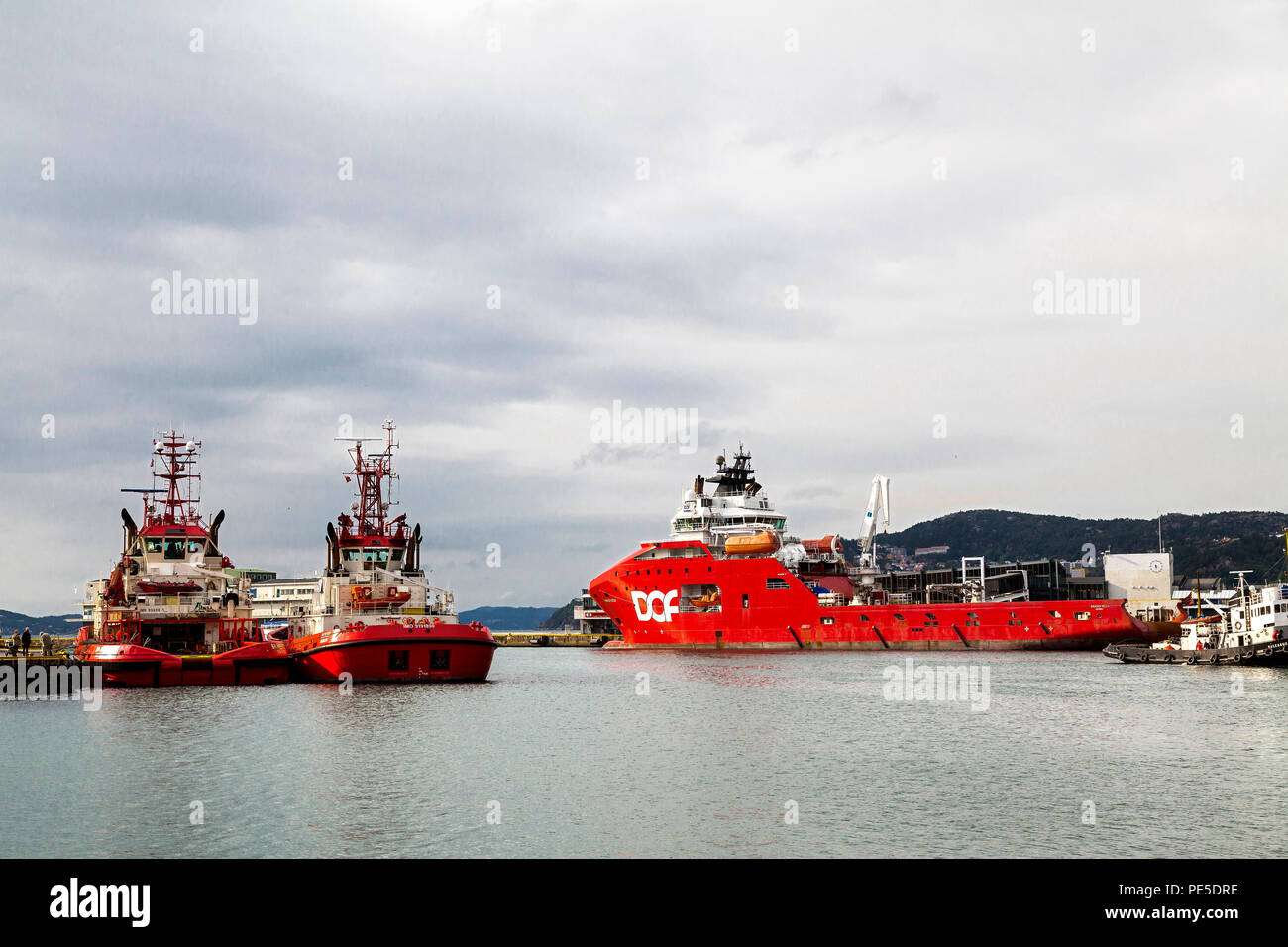 Offshore supply ships and tugs berthed in the port of Bergen, Norway. Skandi Vega (b.2010 ...