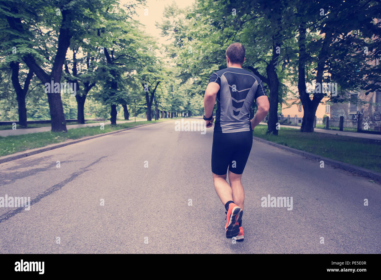 fit muscular male runner training for marathon running on beautiful ...