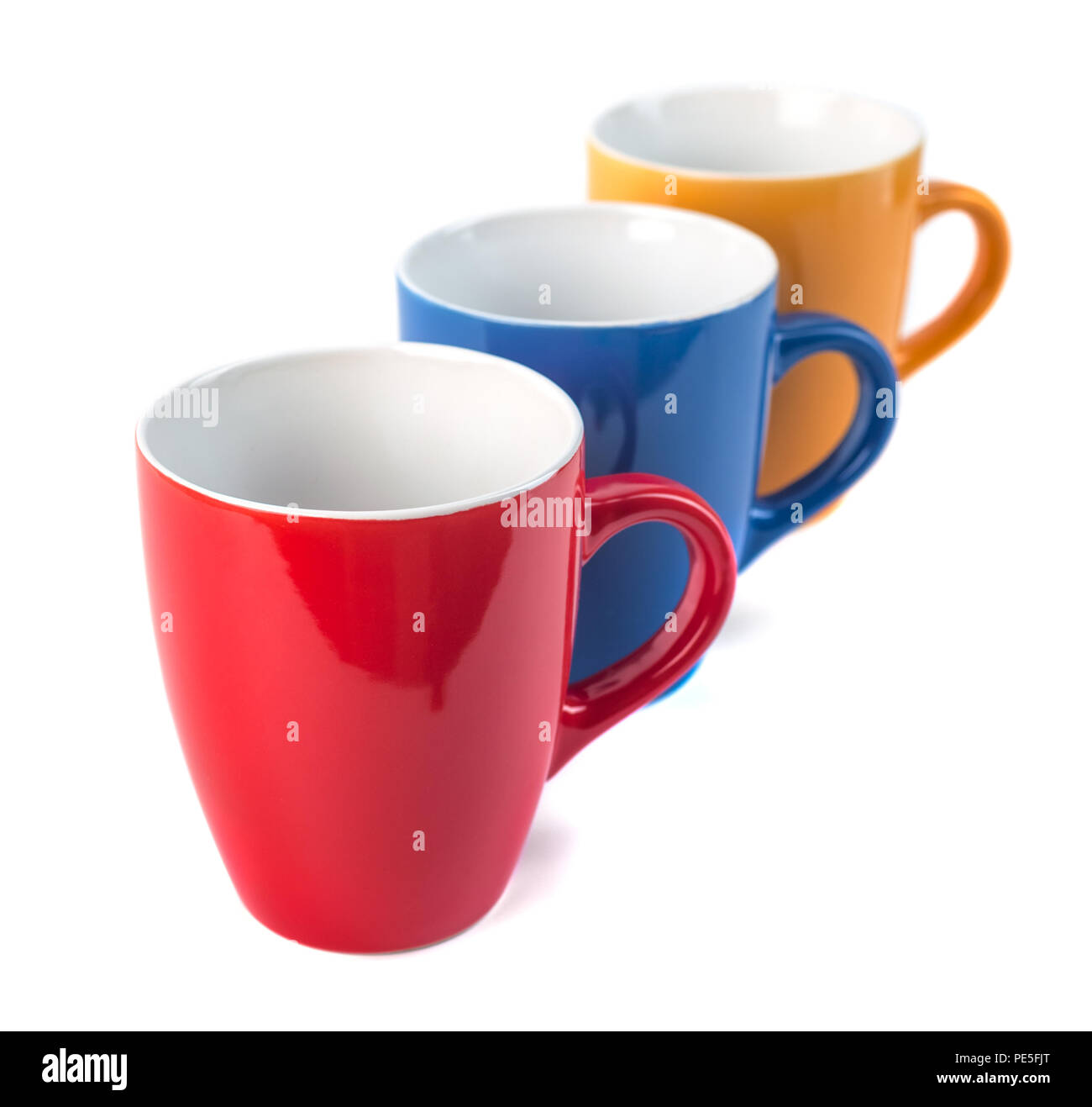 Three color ceramic cups on a white background Stock Photo - Alamy