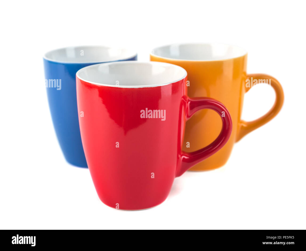 Three color ceramic cups on a white background Stock Photo - Alamy