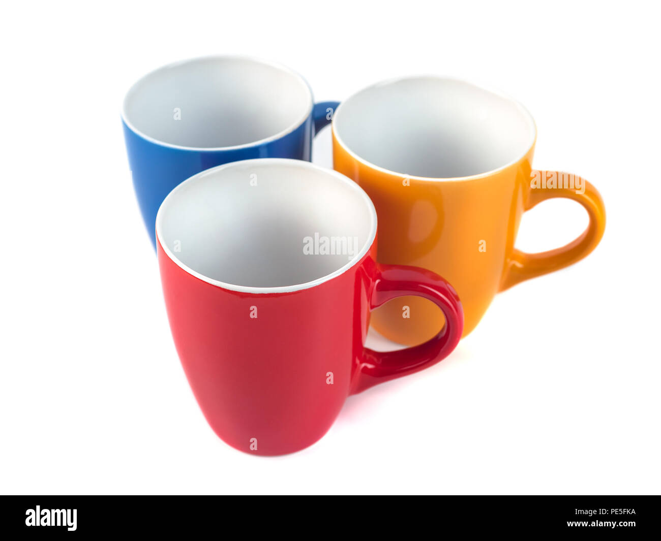 Three color ceramic cups on a white background Stock Photo - Alamy