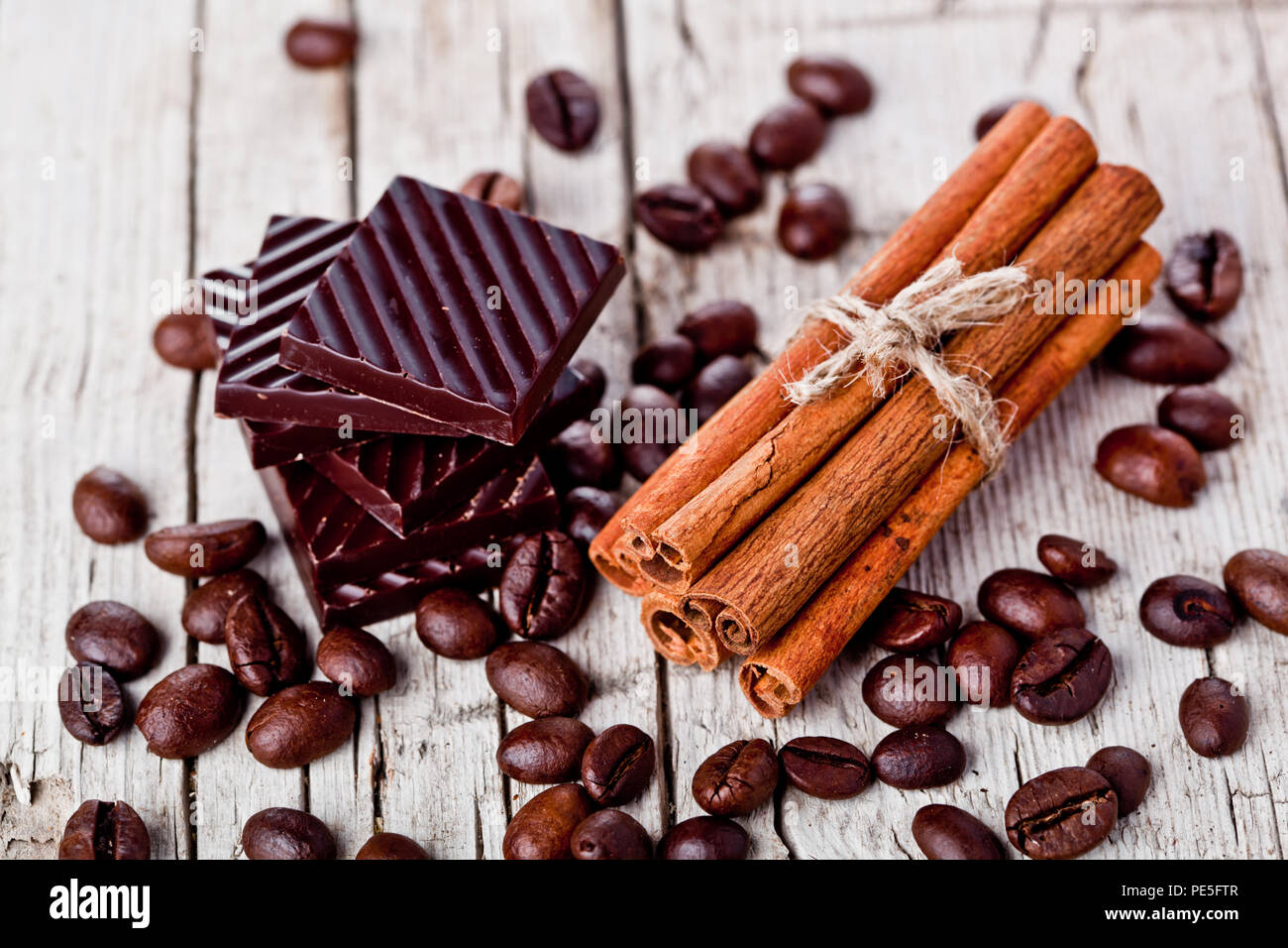 chocolate sweets and coffee beans on rustic wooden background Stock ...