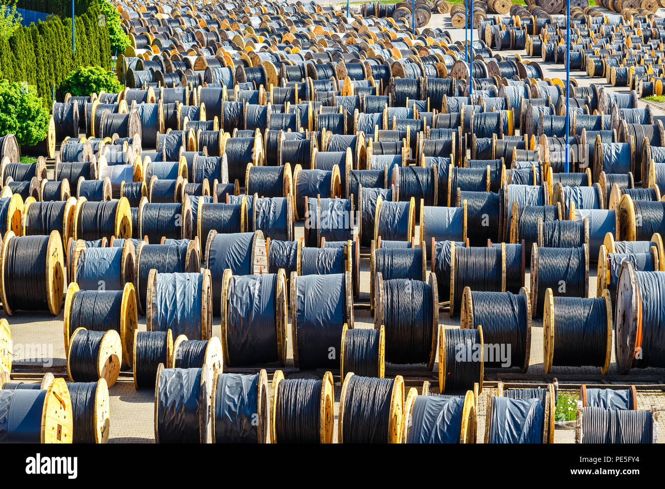electricity cable on wooden spools on the floor Stock Photo - Alamy