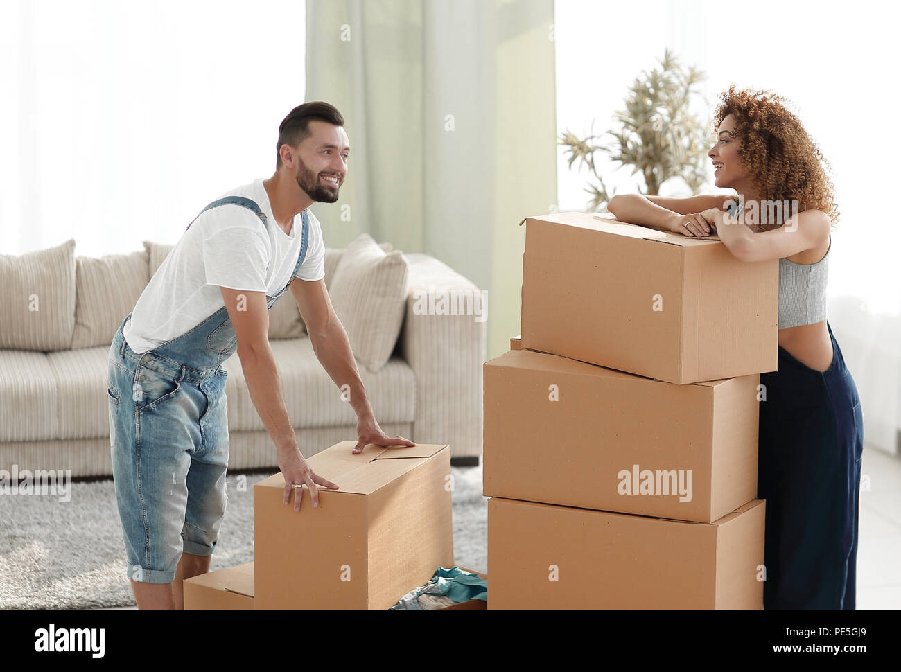 Happy and young couple looking at boxes Stock Photo - Alamy