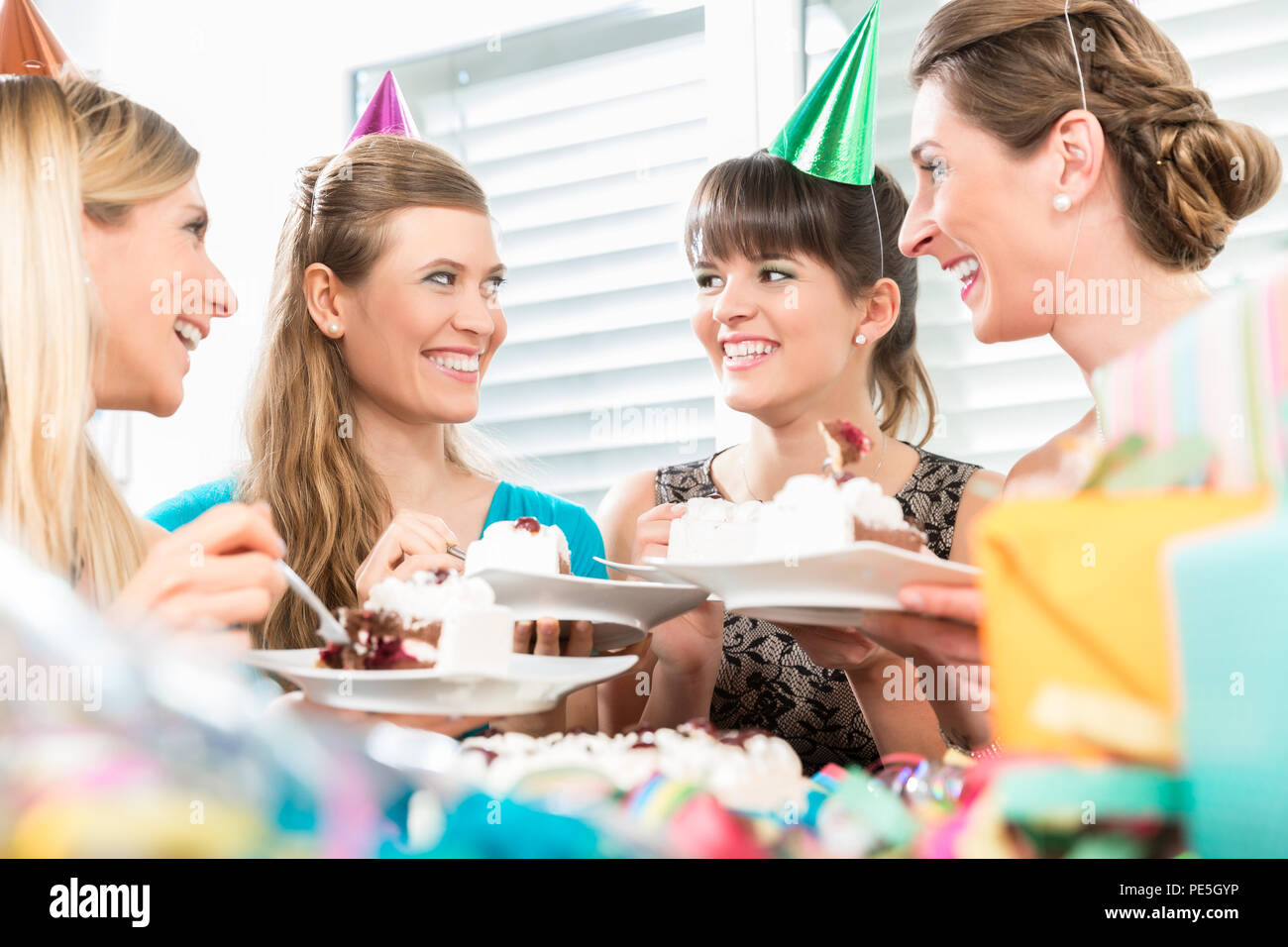 Beautiful female best friends sharing a birthday cake Stock Photo - Alamy