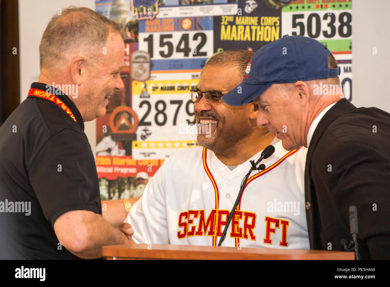 Race Director Rick Nealis shakes hands with a member of the Marine ...