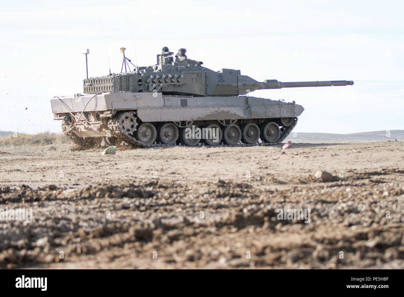 A Spanish Leopard 2 tank maneuvers through the battle space of the ...