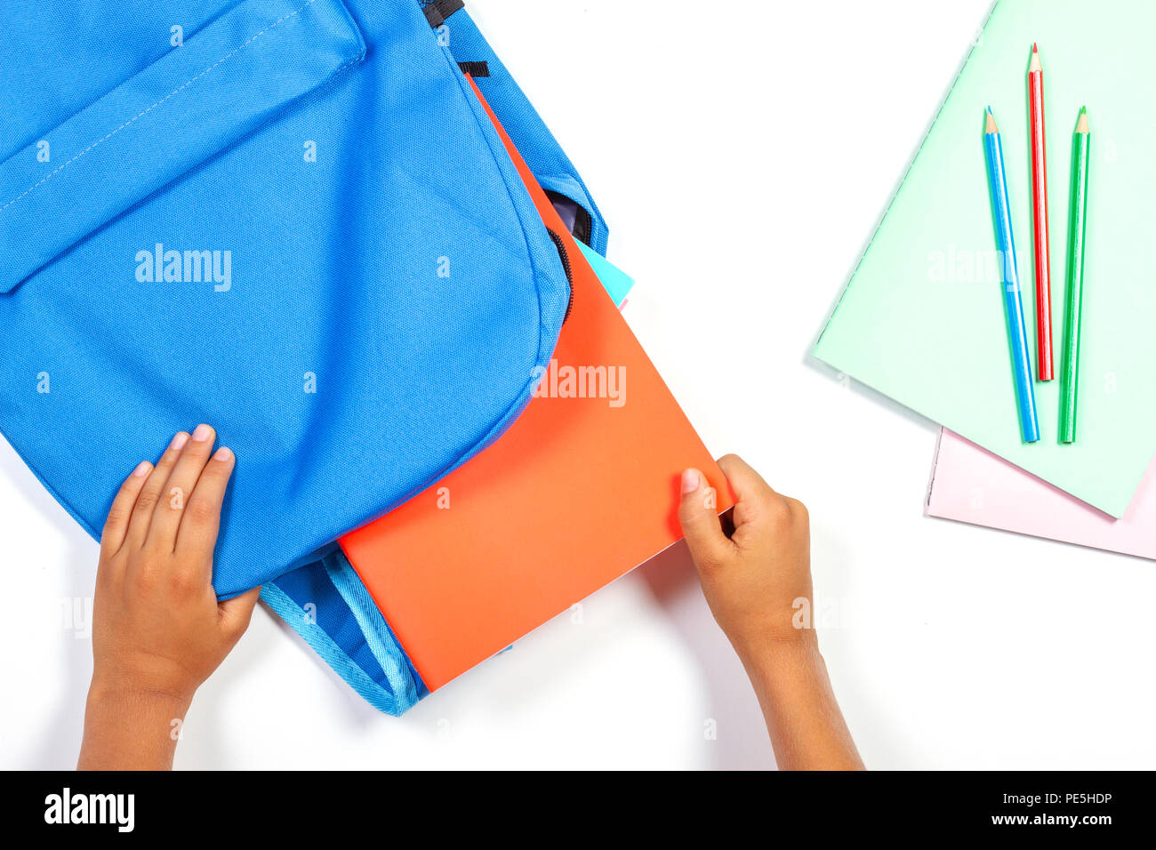 Back to school, education concept. Kid hands packing backpack and ...