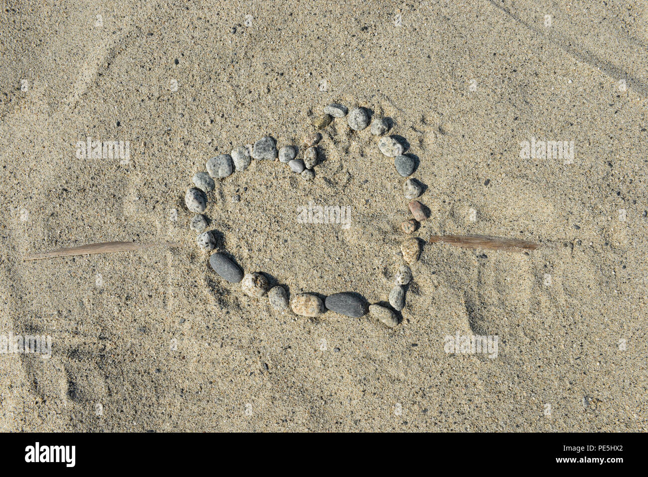stones heart shape on a beach sand by the sea Stock Photo - Alamy