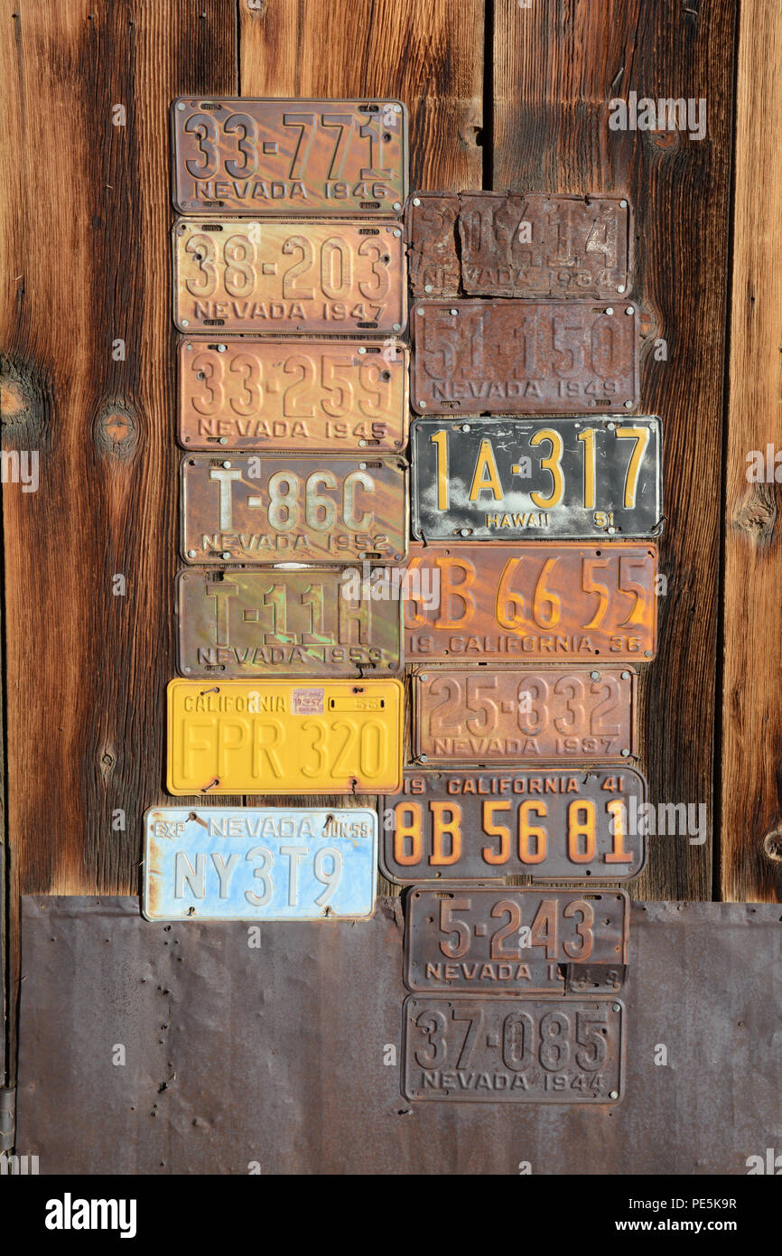 A collection of old license plates on a wooden wall Stock Photo - Alamy