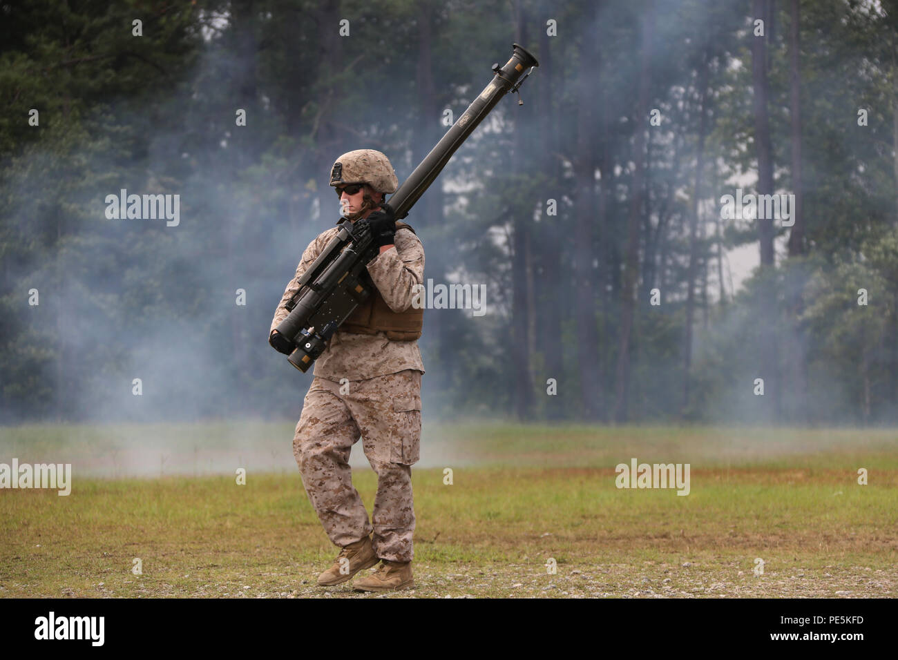 A Marine returns from the firing line during a stinger simulation ...