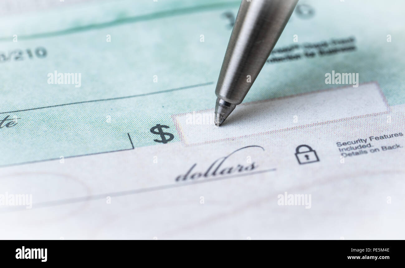 Making payments , writing the check Stock Photo - Alamy