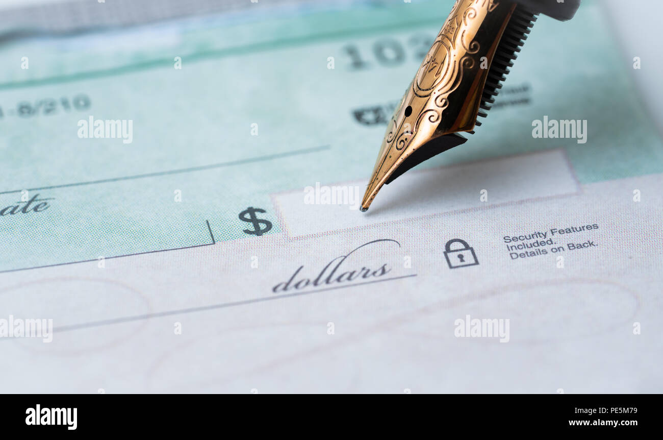 Making payments , writing the check Stock Photo - Alamy