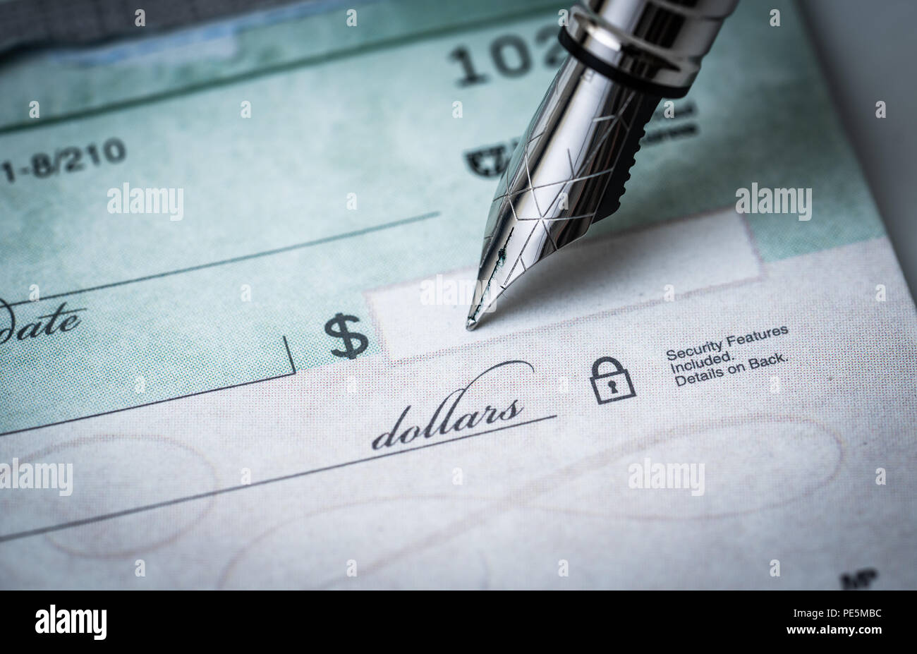 Making payments , writing the check Stock Photo - Alamy