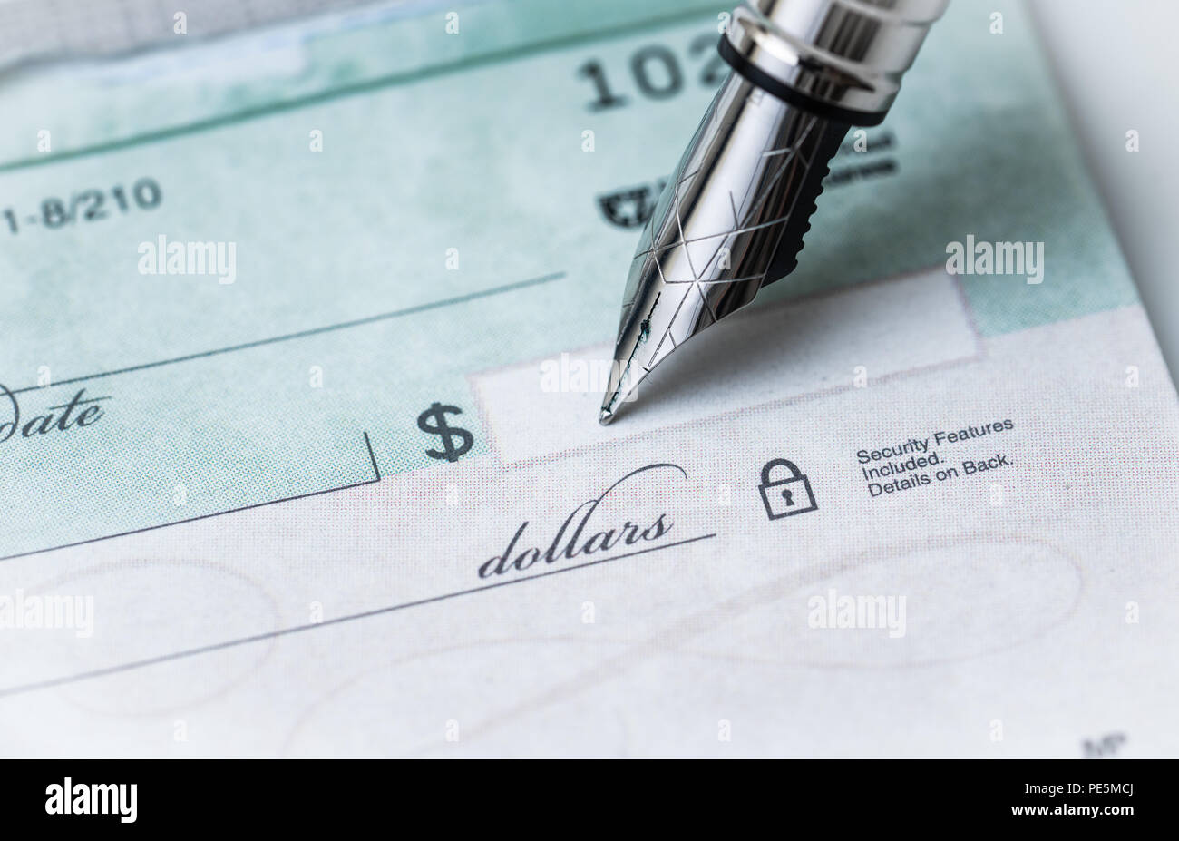 Making payments , writing the check Stock Photo - Alamy