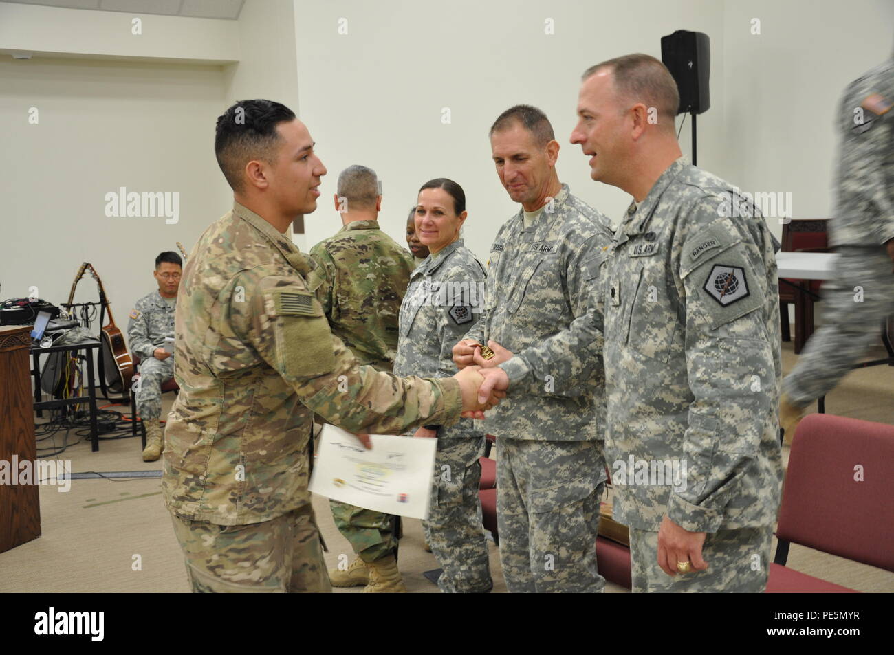 Spc. Erick Aguilar shakes hands with the official party during the ...