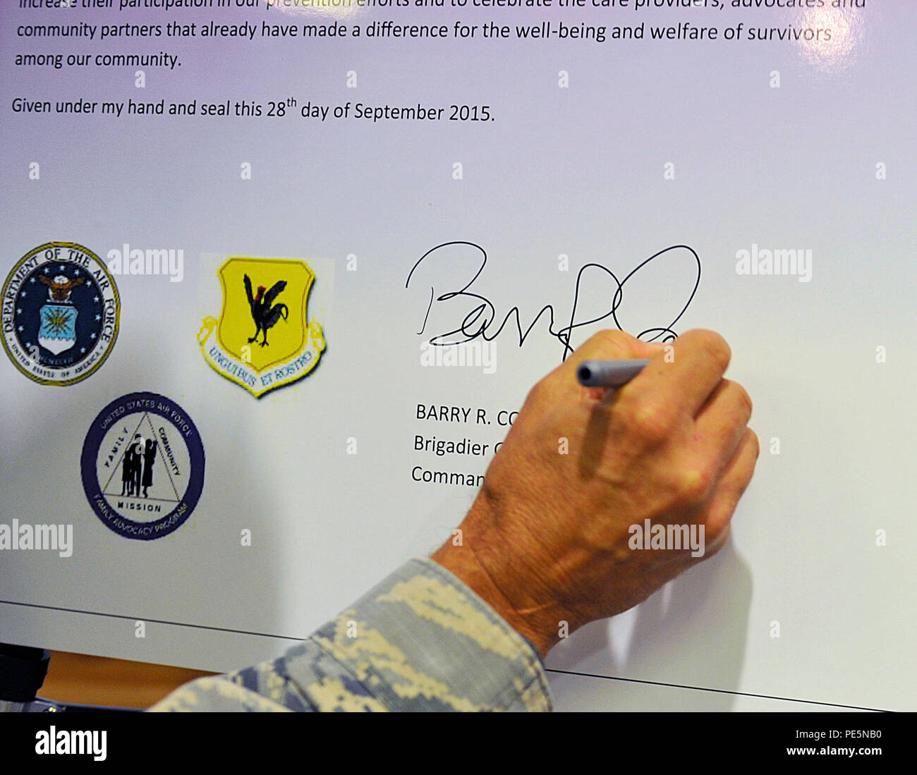 U.S. Air Force Brig. Gen. Barry Cornish, 18th Wing commander, signs a ...