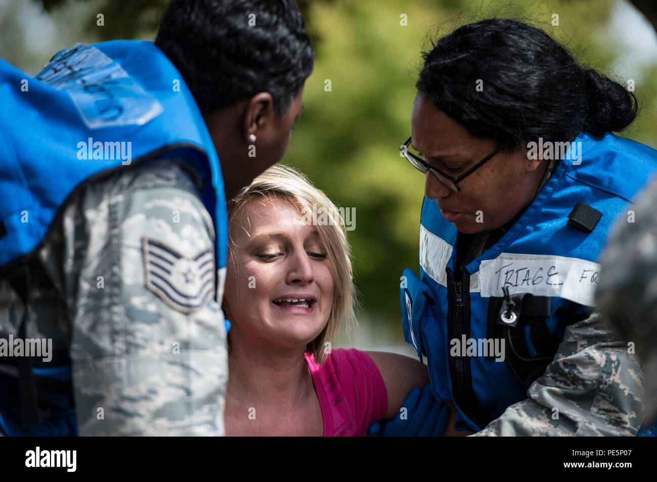 U.S. Air Force medical personnel help a simulated injured woman during ...