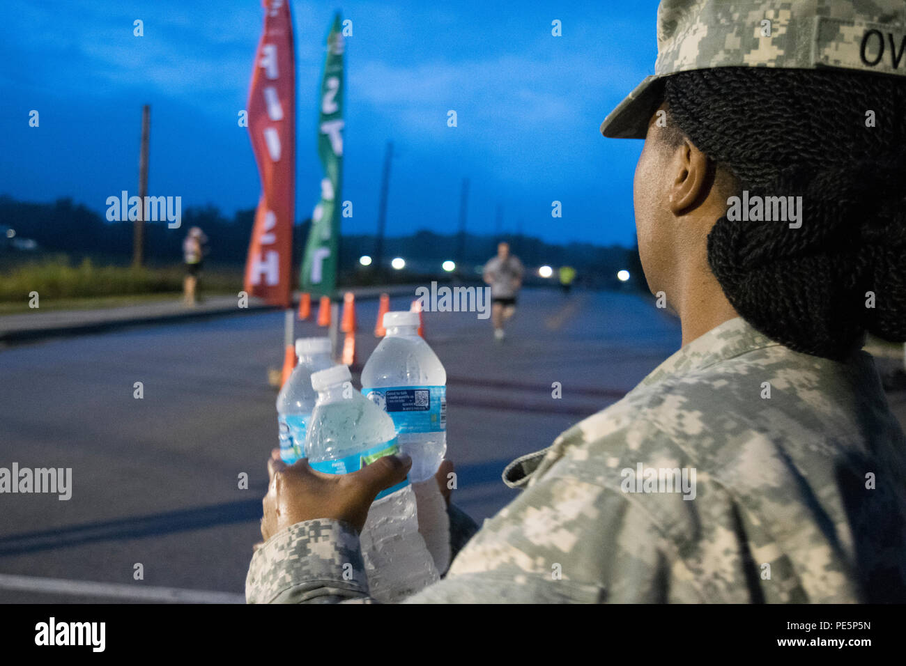 An HRC Soldier waits with water at the finish line of HRC’s Men’s ...