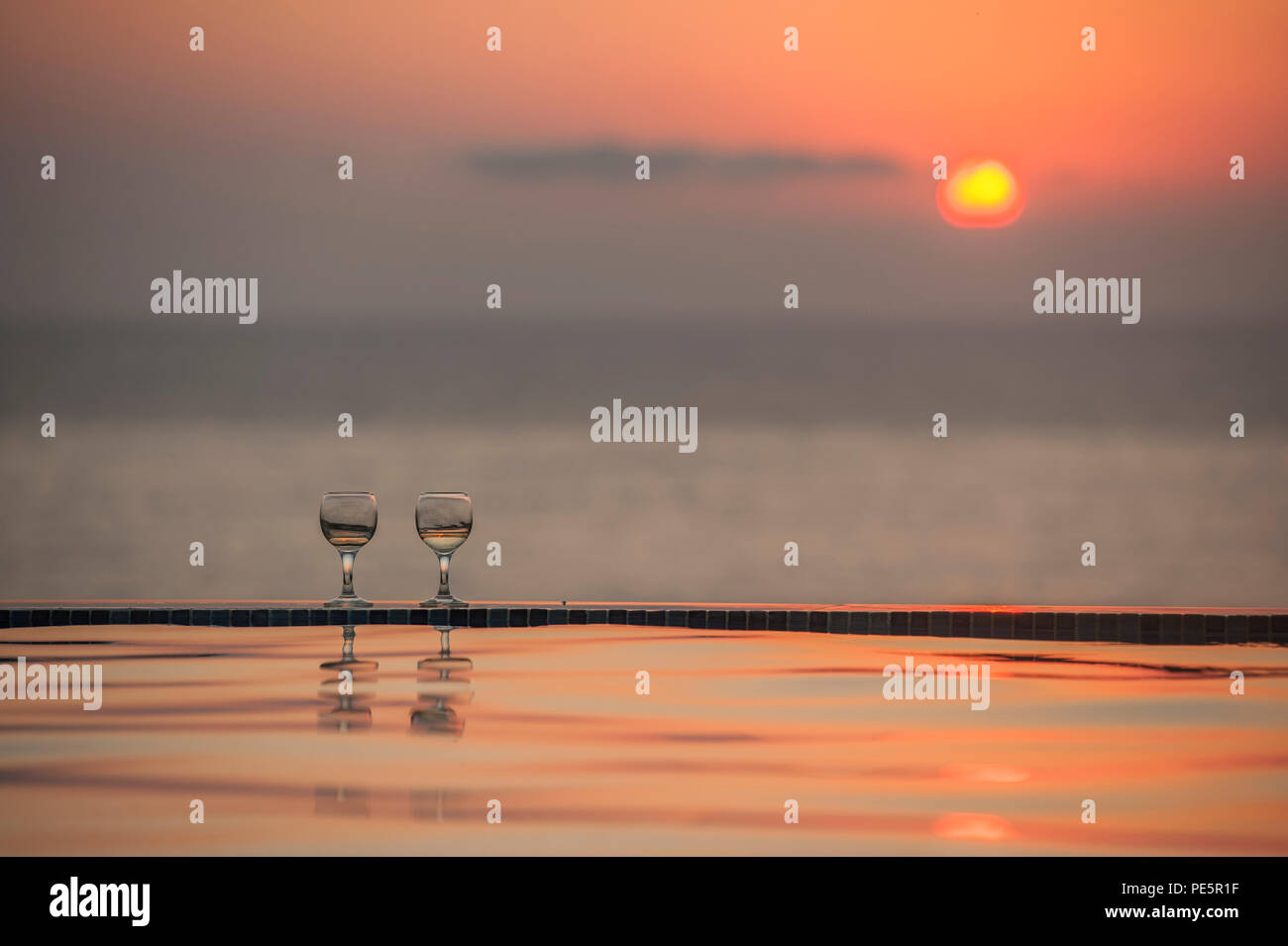 Champagne by an infinity pool as the sun sets Stock Photo - Alamy