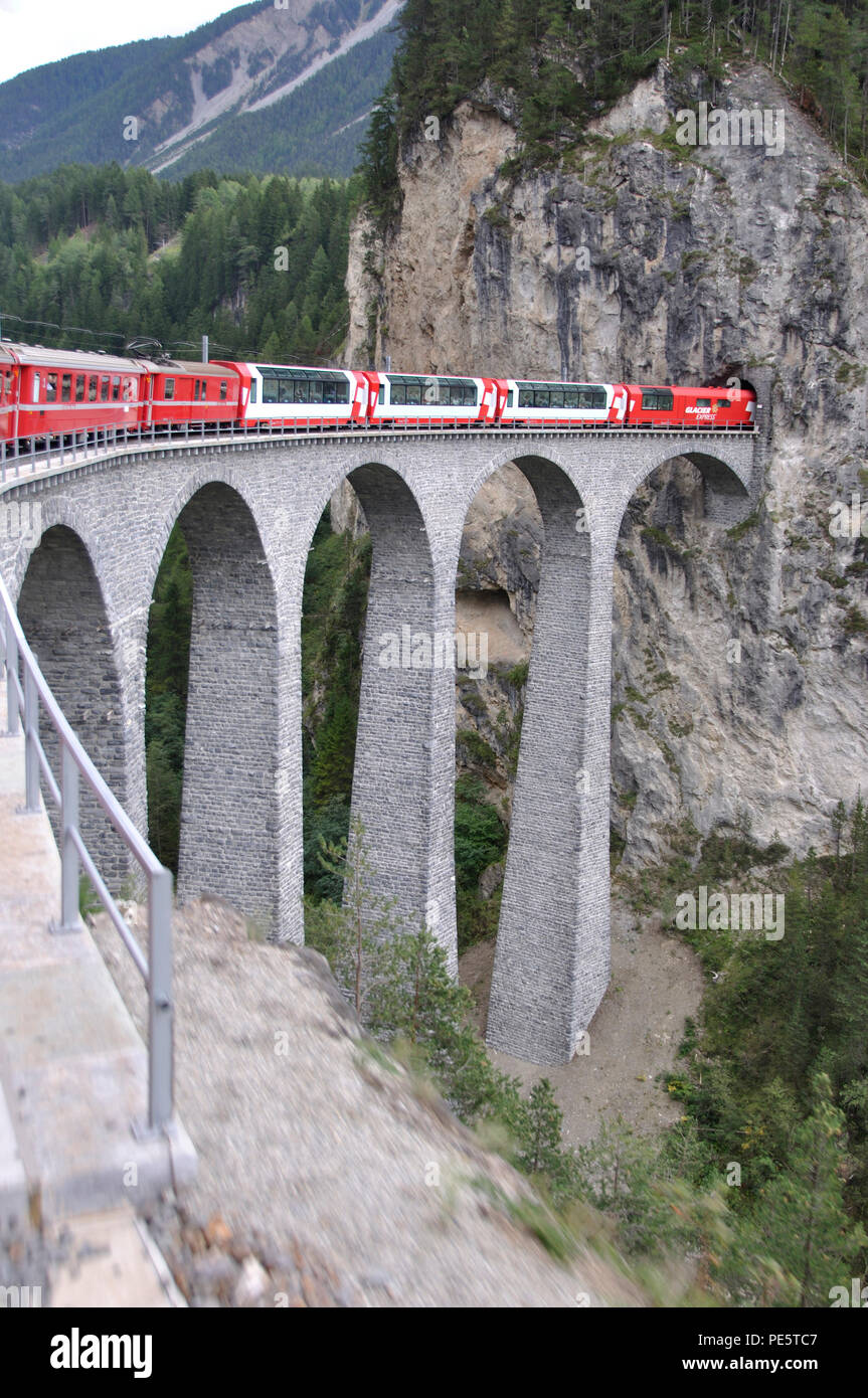 The glacier Express train is driving across the swiss alps and through ...
