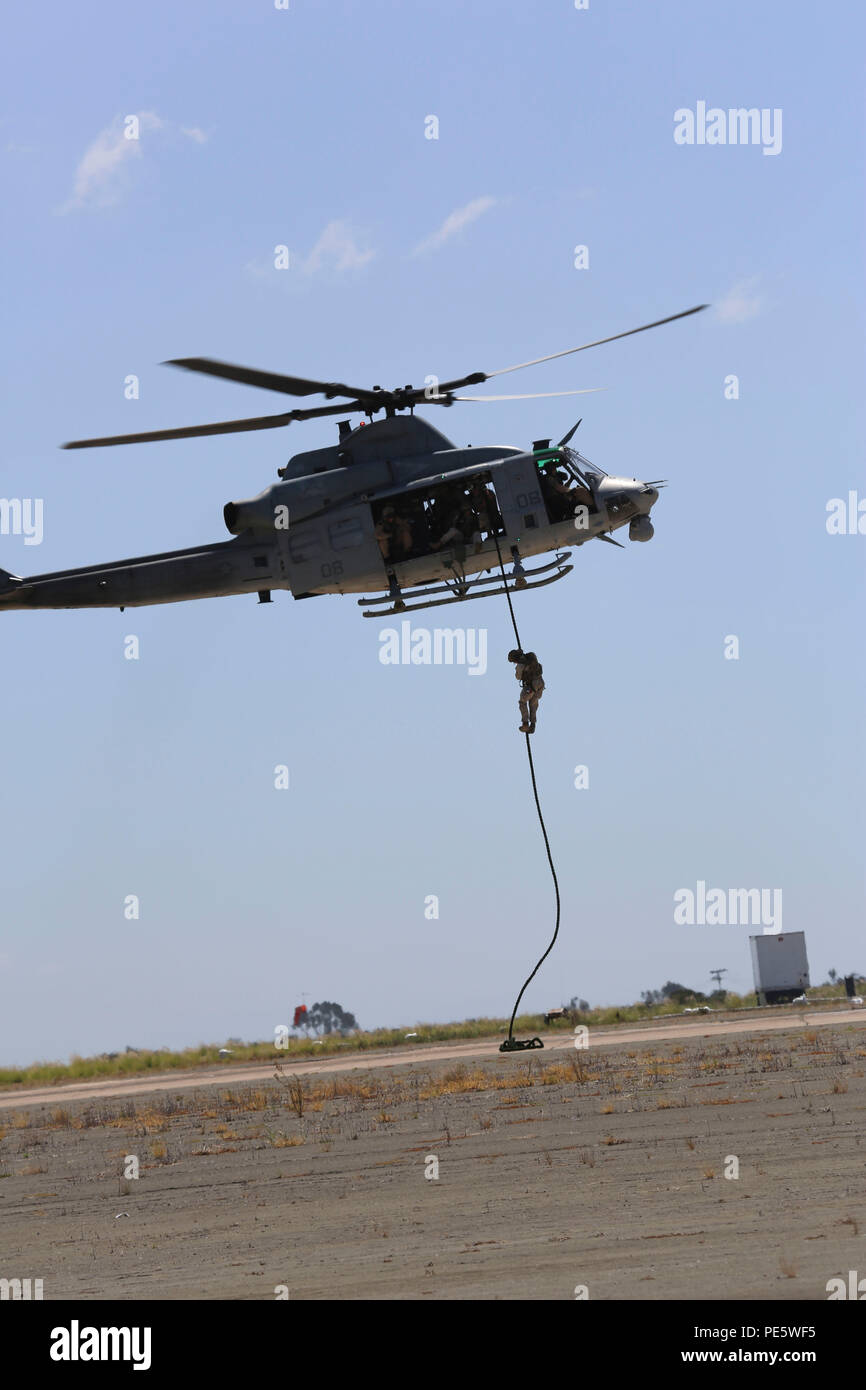 Marines with 1st Marine Division fast rope out of a UH-1Y Huey while ...