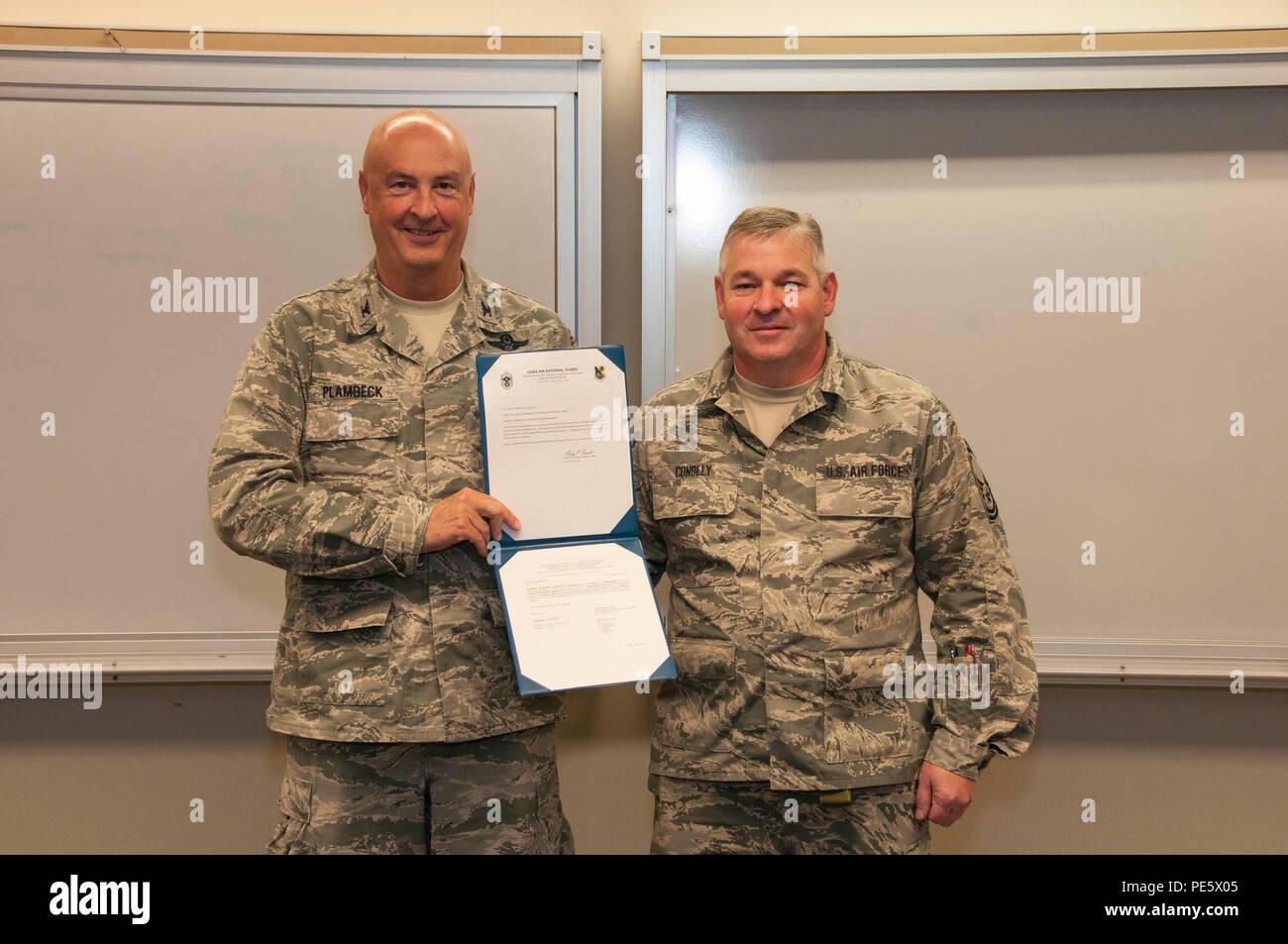 Maintenance group commander Col. Scott Plambeck presents Moville native ...