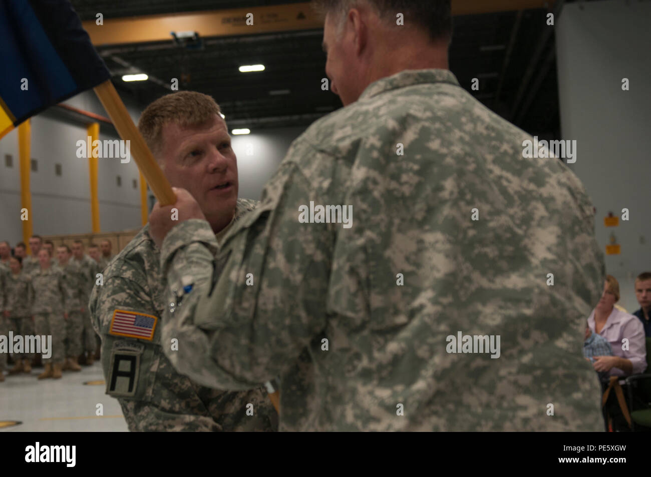 Lt. Col. David Foster, outgoing commander, 86th Troop Command, hands ...