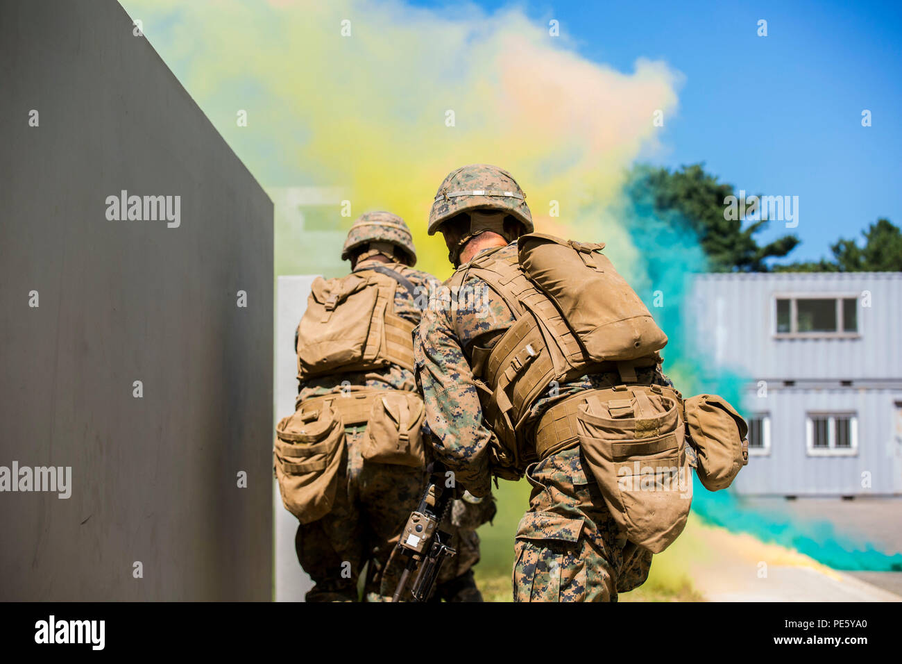 U.S. Marines and ROK Marines breach a building under smoke concealment ...