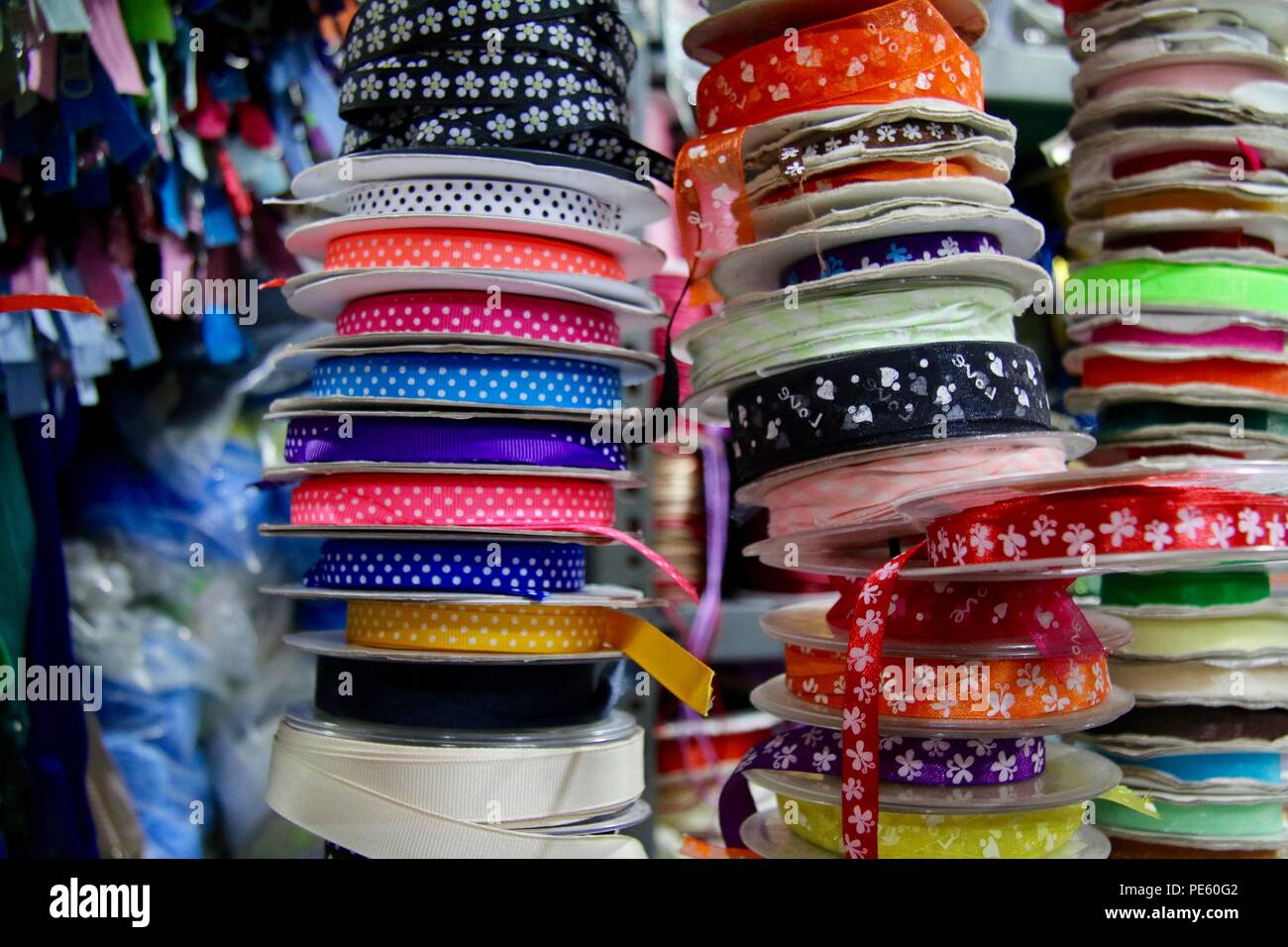 Stacks of multicoloured ribbons of various widths, patterns and ...