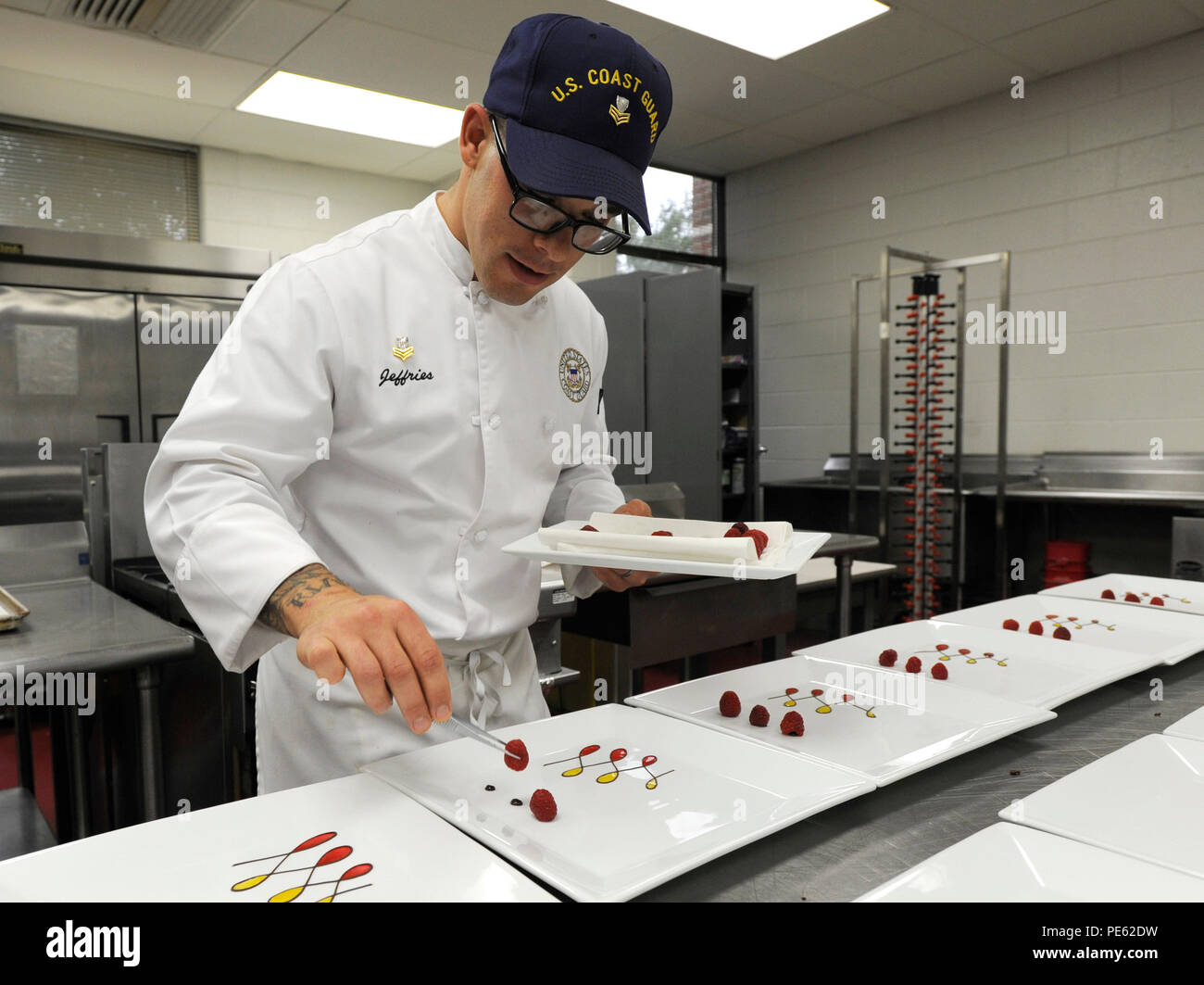 Petty Officer 1st Class Scott Jeffries prepares the dessert course ...